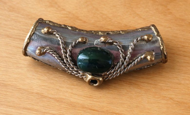 This was found in an old woman’s jewelry box. It’s open at each end and ...